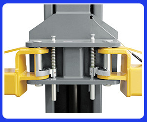 Close-up view of car lift's hydraulic cylinders and chain system