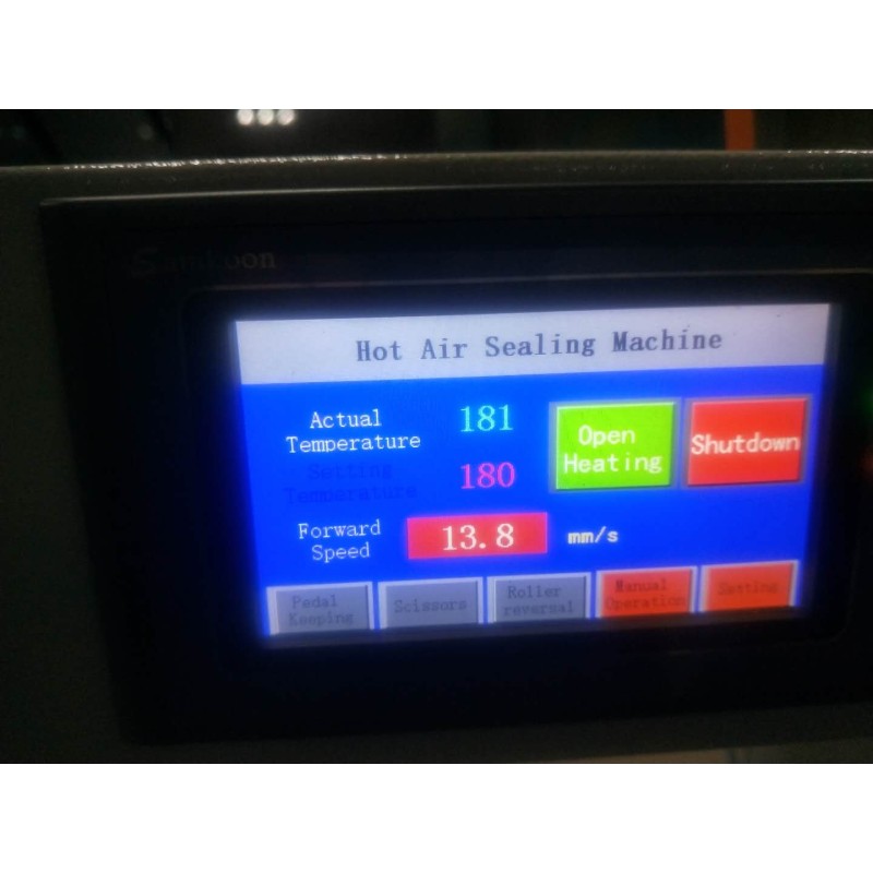 Close-up view of PLC control panel and rollers