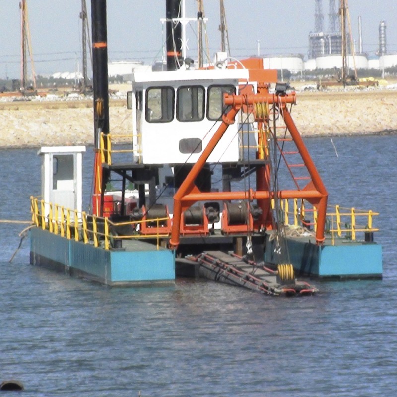 Close-up of dredger operation in water