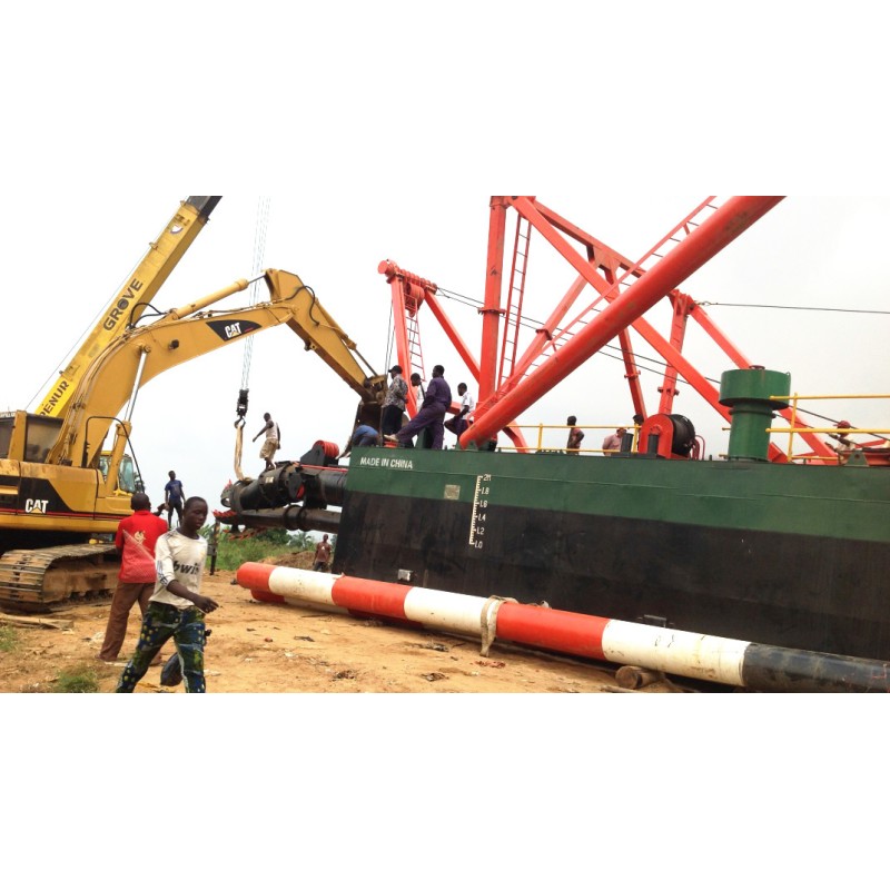 Technicians assembling dredger components