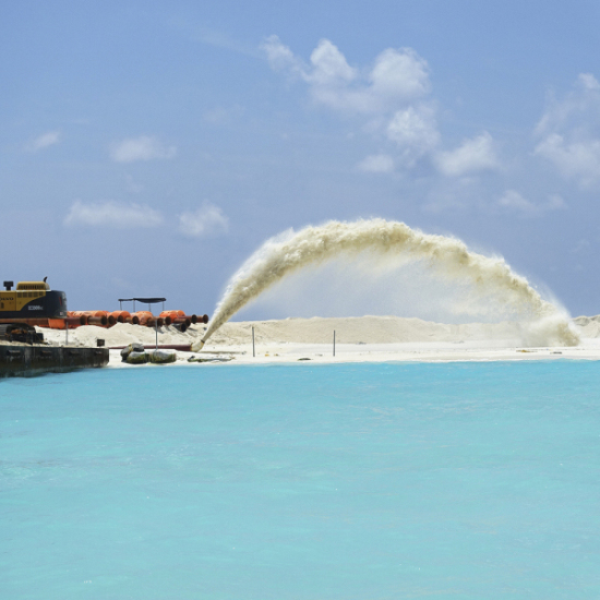 Close-up of dredger operations in river environment