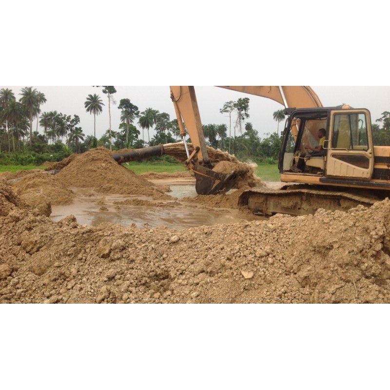 Dredger discharging sediment at reclamation site