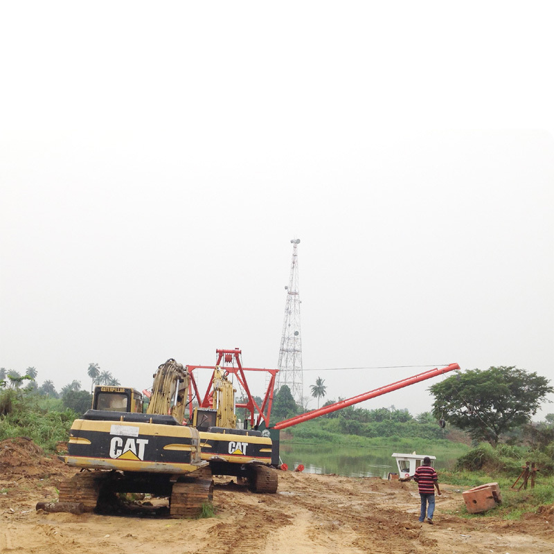 Dredger discharging sediment through pipeline