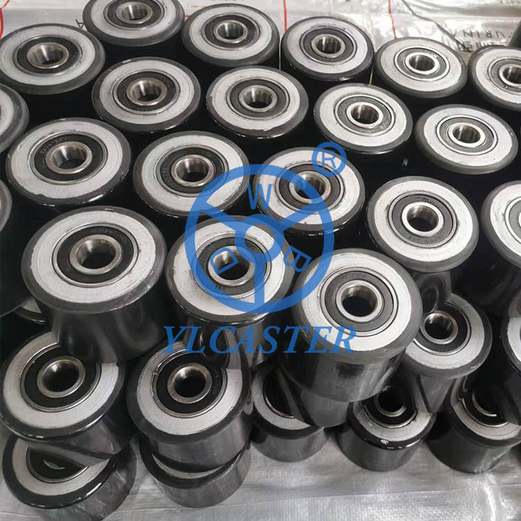 Black iron polyurethane pallet truck wheel with ball bearings in bulk on table 1-YLcaster
