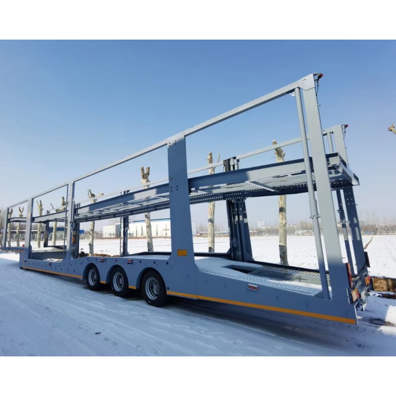 Side view of 3-axle car transport trailer showing loading deck